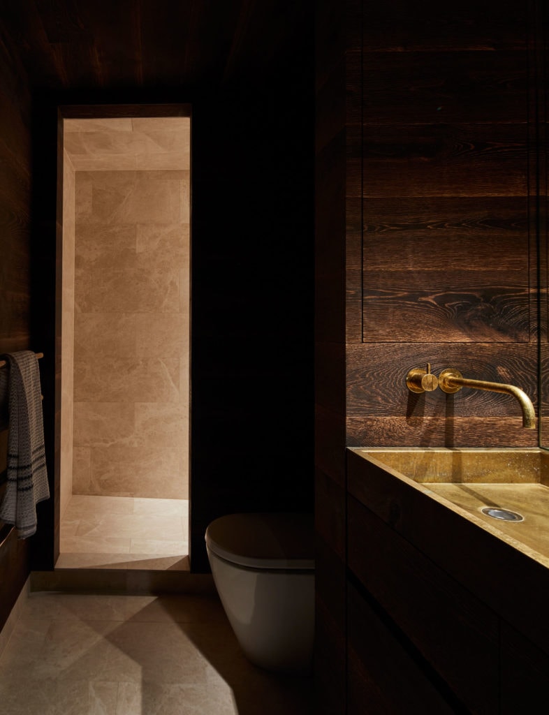 A windowless bathroom in a small apartment is given a luxurious redesign