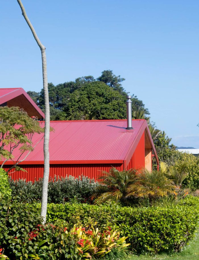 Here's why this striking red bach chose the paddock over a beach view